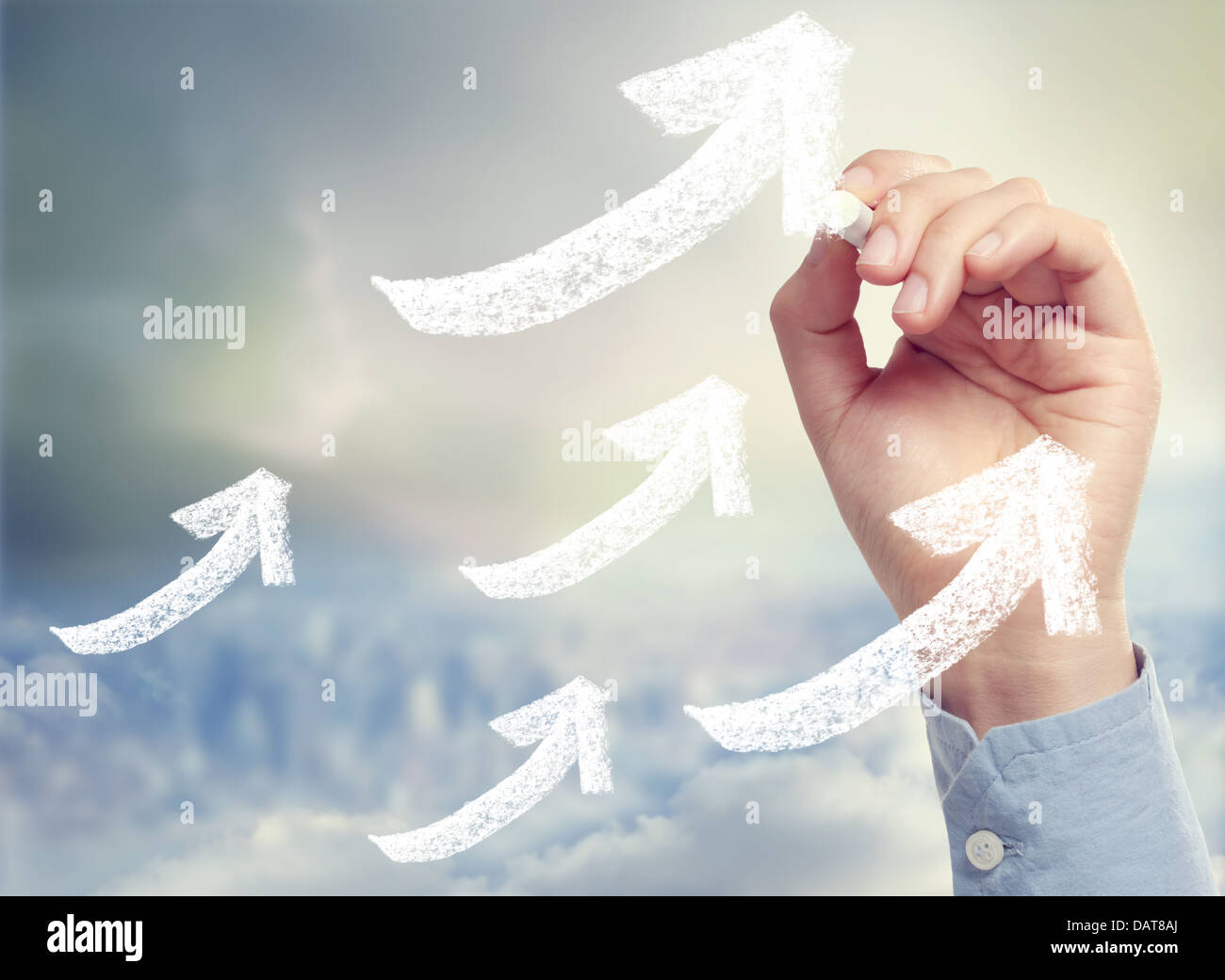 Rising arrows in hand drawn chalk in the clouds over sky backdrop Stock ...