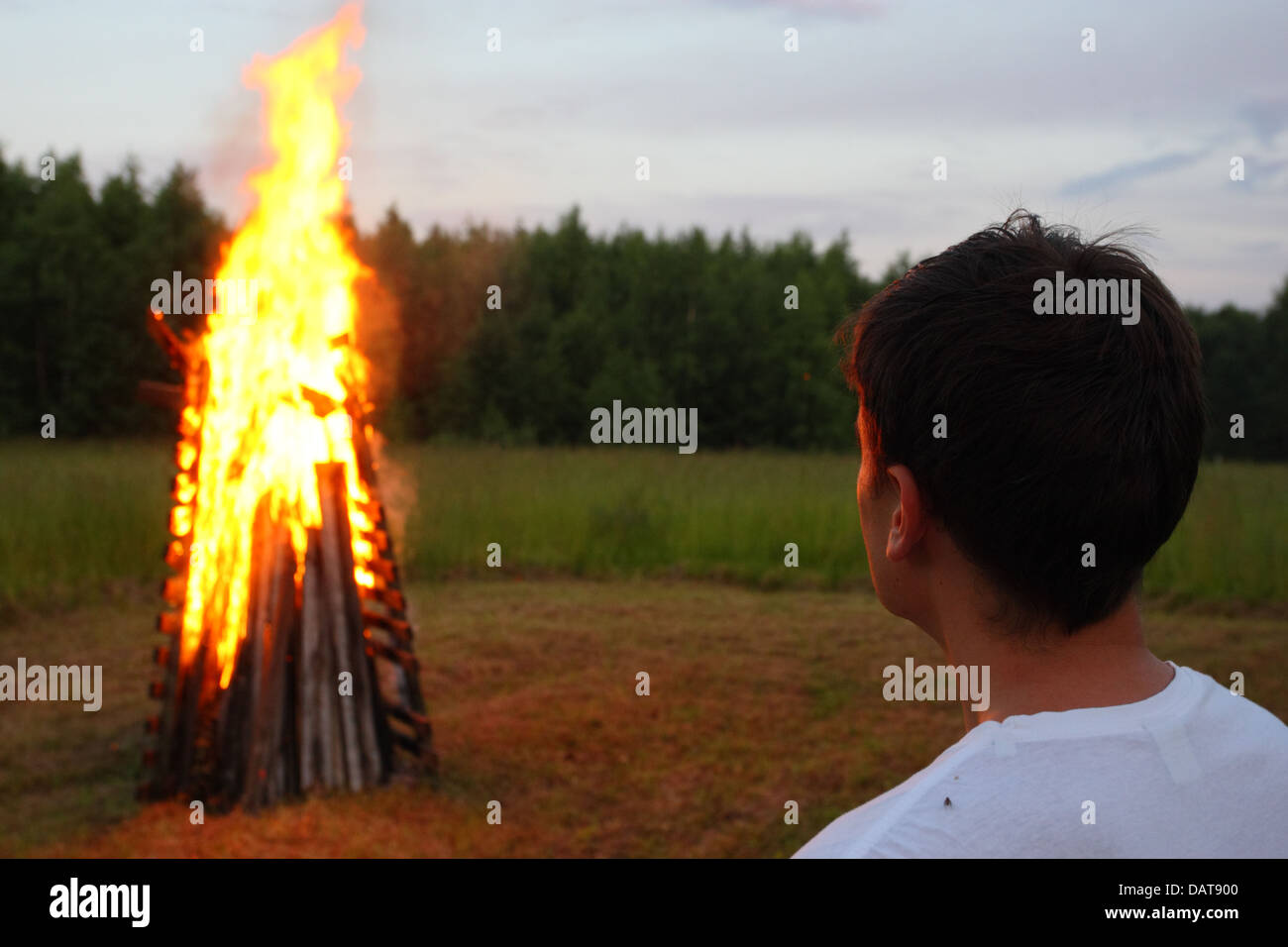 Man watching Midsummer bonfire 23.june, Estonia Stock Photo - Alamy