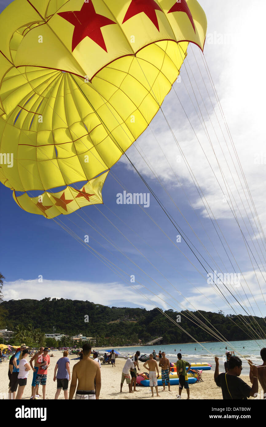 Parasail operators prepare a canopy for ride on Patong Beach Stock ...