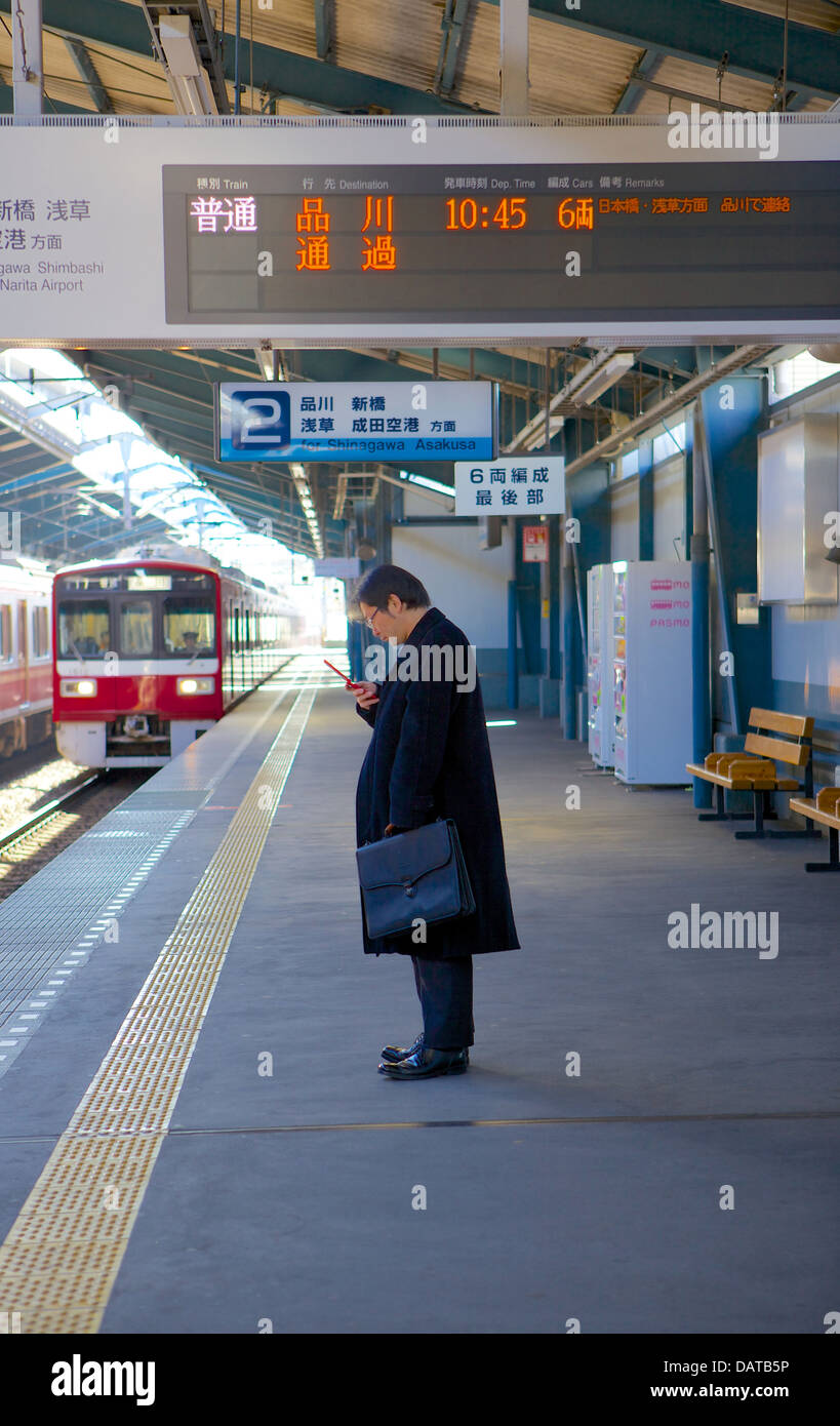 Commuter at a metro stop, Tokyo, Japan Stock Photo - Alamy
