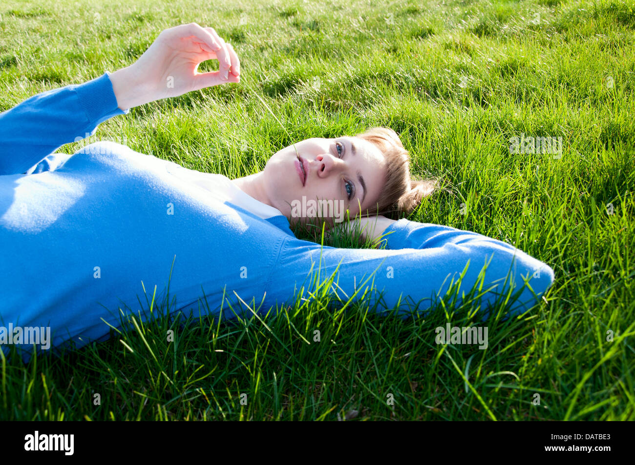 beautiful girl lying on the grass Stock Photo - Alamy