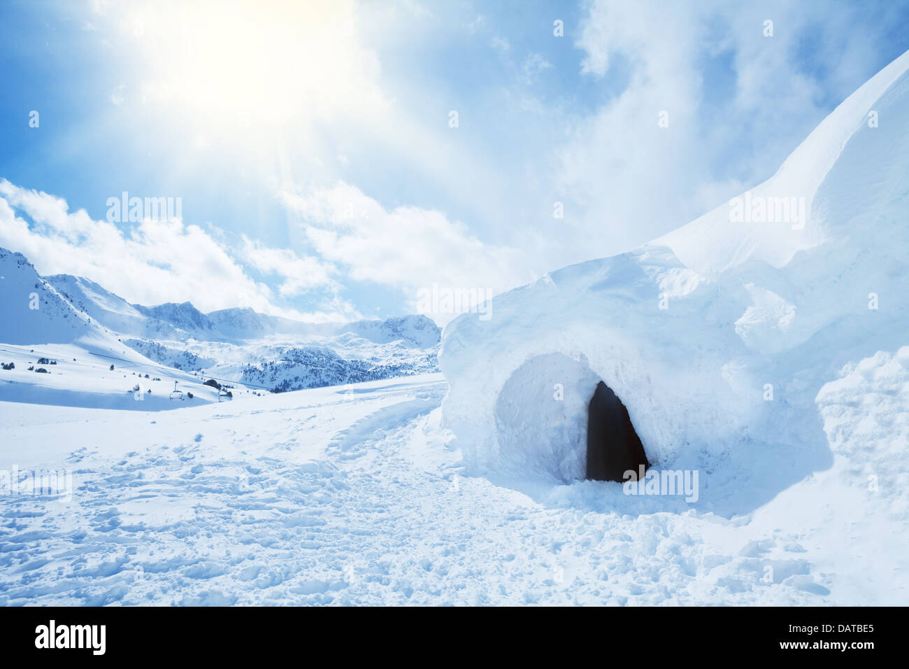 igloo and snow shelter in high snowdrift with mountains peaks on ...