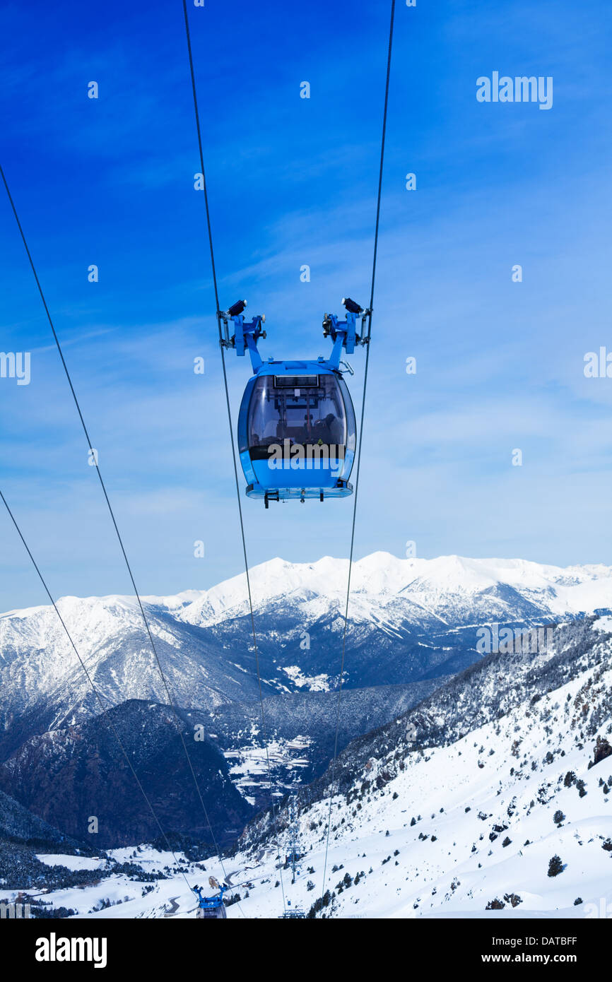 Front view of ski lift cable car with valley and mountains on the ...