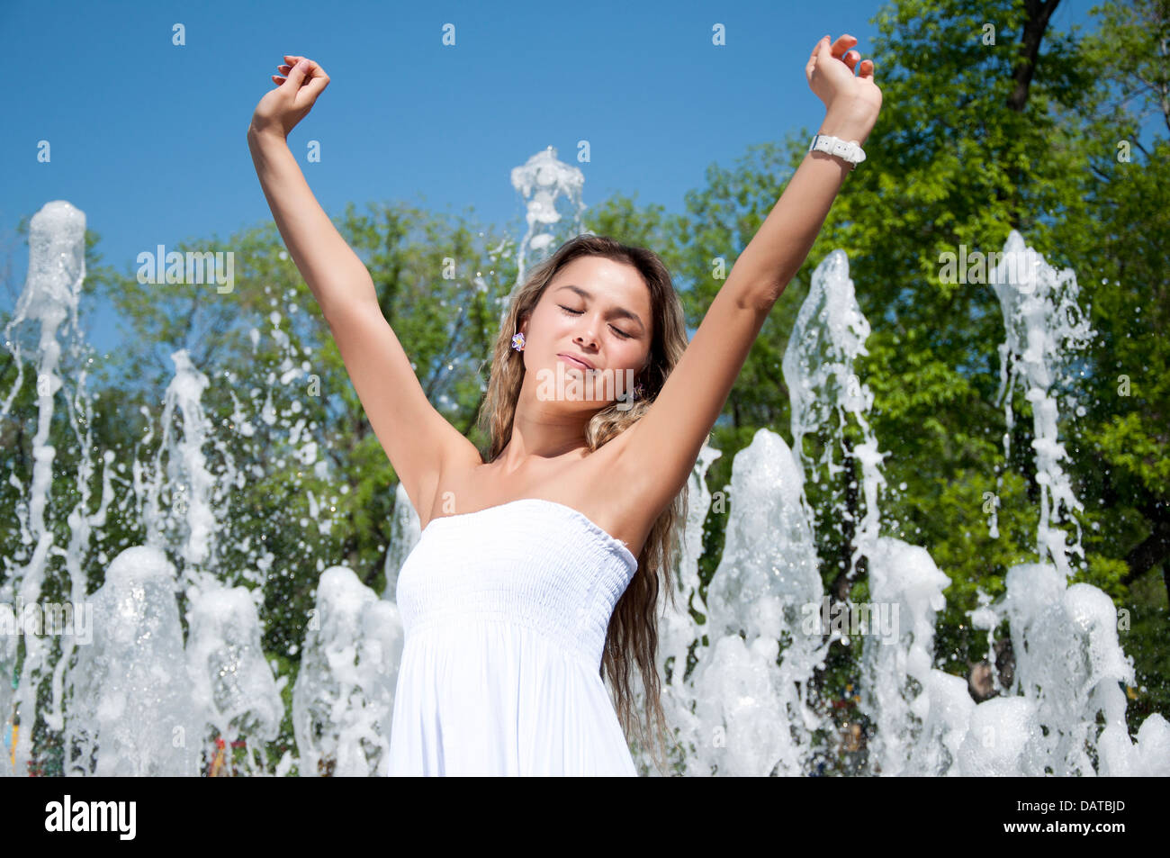 young woman lifts upwards hands Stock Photo - Alamy