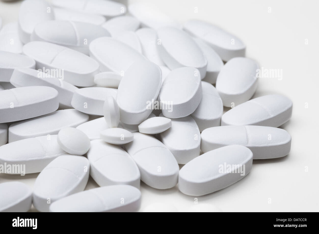 Pile of white long tablets laying on white tablet Stock Photo - Alamy