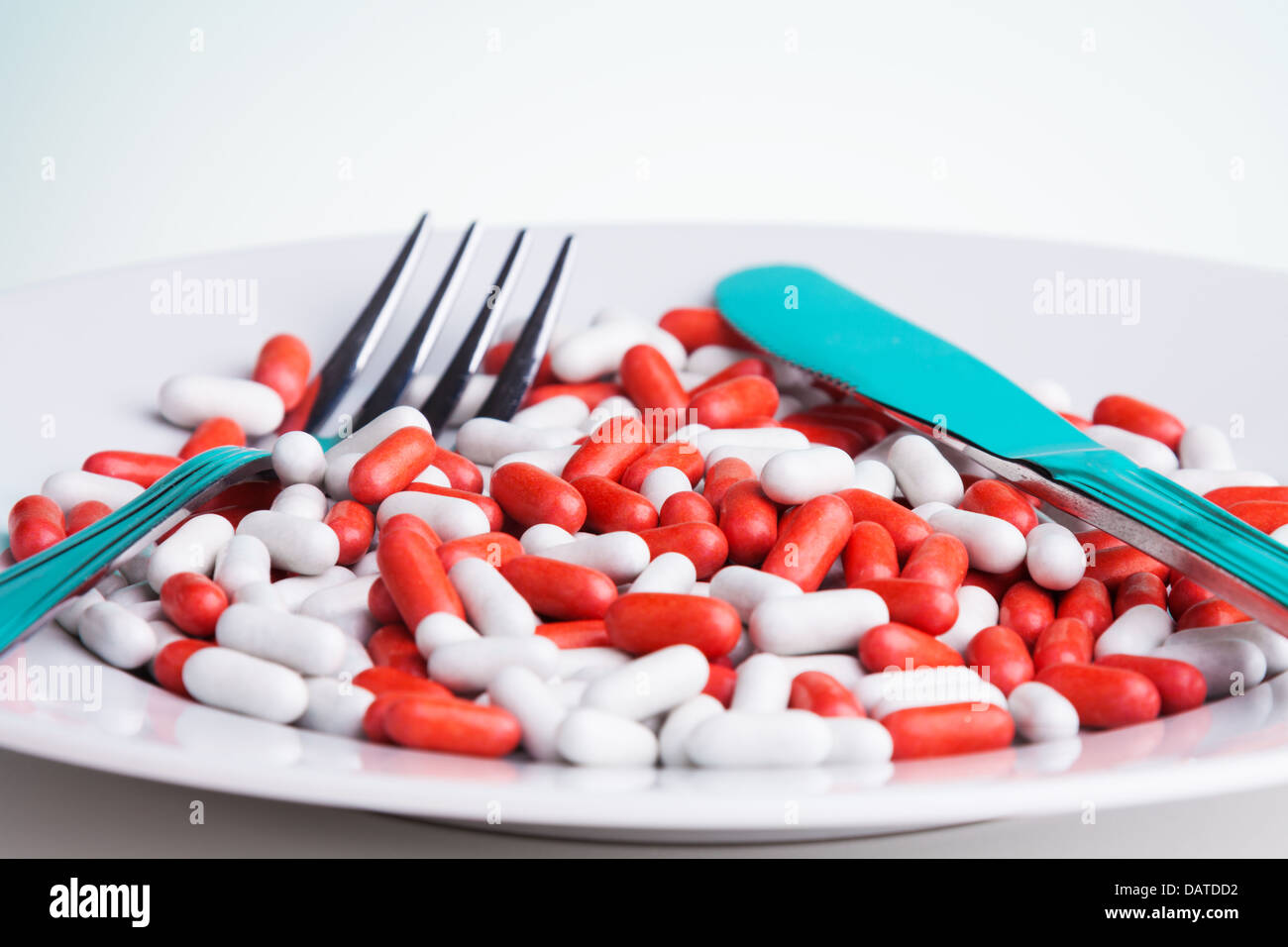 Medicine for digestion concept with plate with many white and red ...