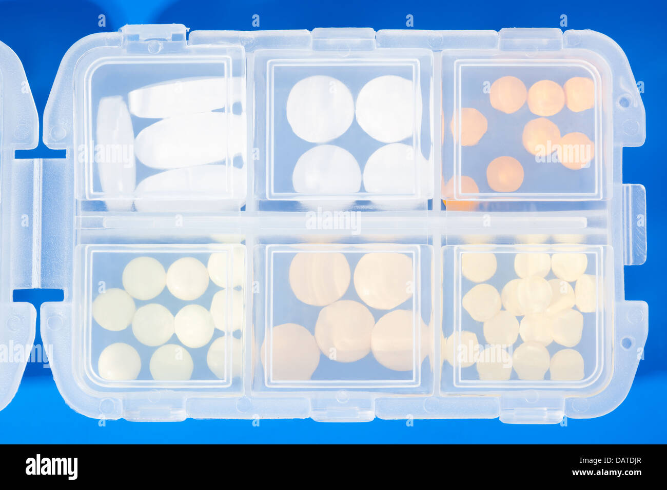 Closeup of plastic container full of different drugs for different days ...