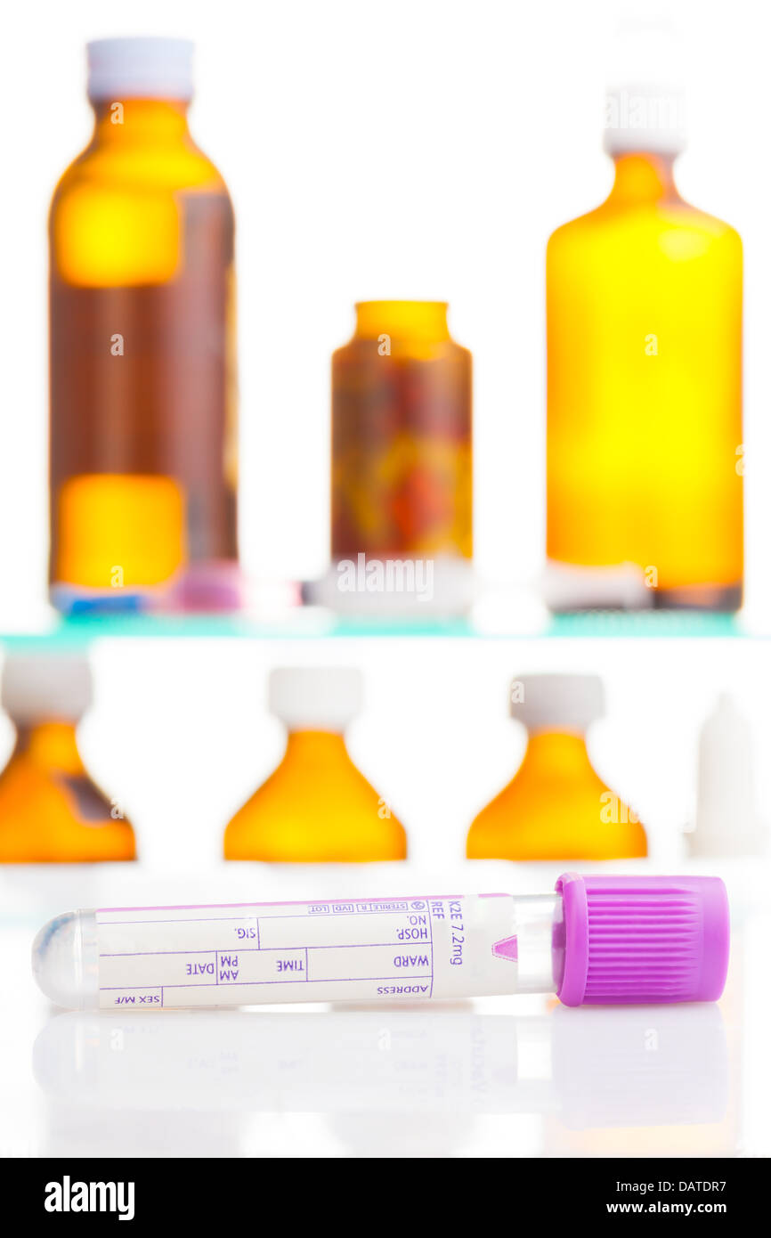 Blood sample tube and shelf with jars and other medicine on background ...