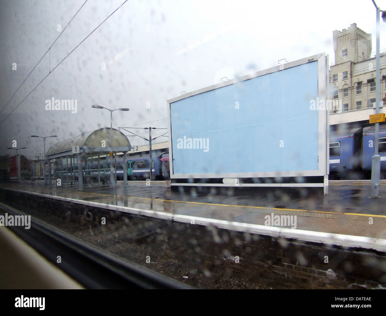 Blank advertising billboard / sign. Positioned on a railway platform ...