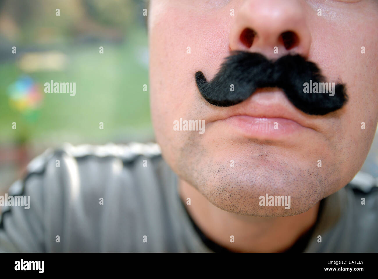 close-up of a man age 20-30 wearing a false mustache Stock Photo - Alamy