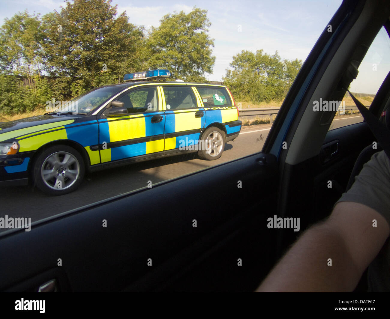 Police car passing a motorist Stock Photo - Alamy