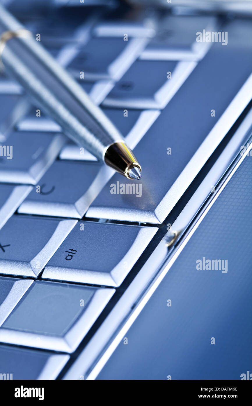 Laptop PC over background and ballpoint Stock Photo - Alamy