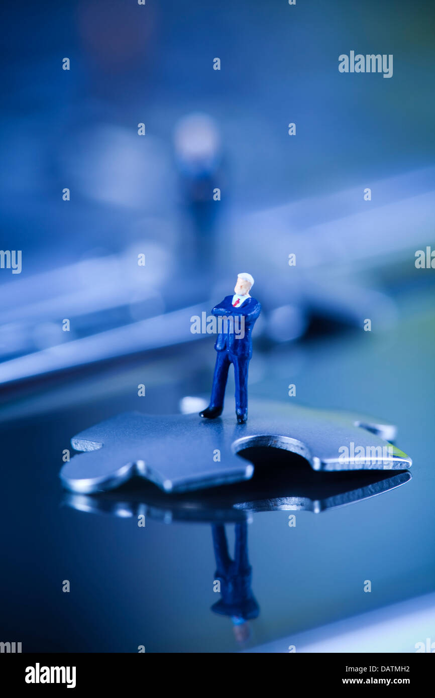 Laptop with figure over chrome background Stock Photo - Alamy