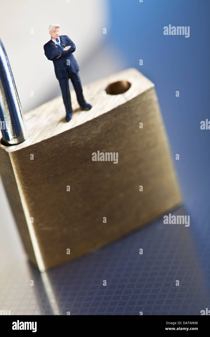 Business man on secure pedlock Stock Photo - Alamy