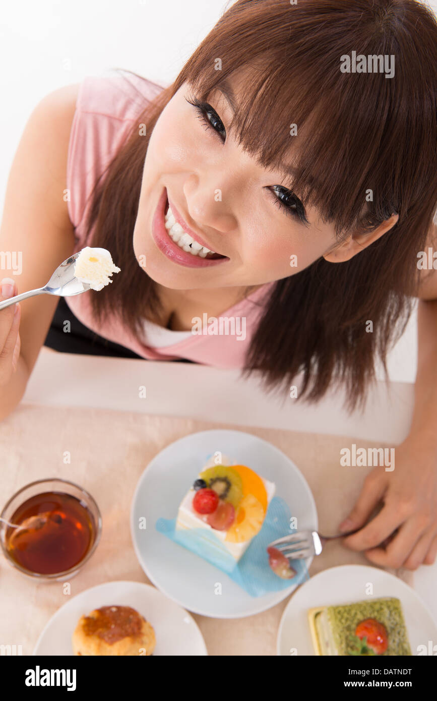 Asian girl enjoying eating cake hi-res stock photography and images - Alamy