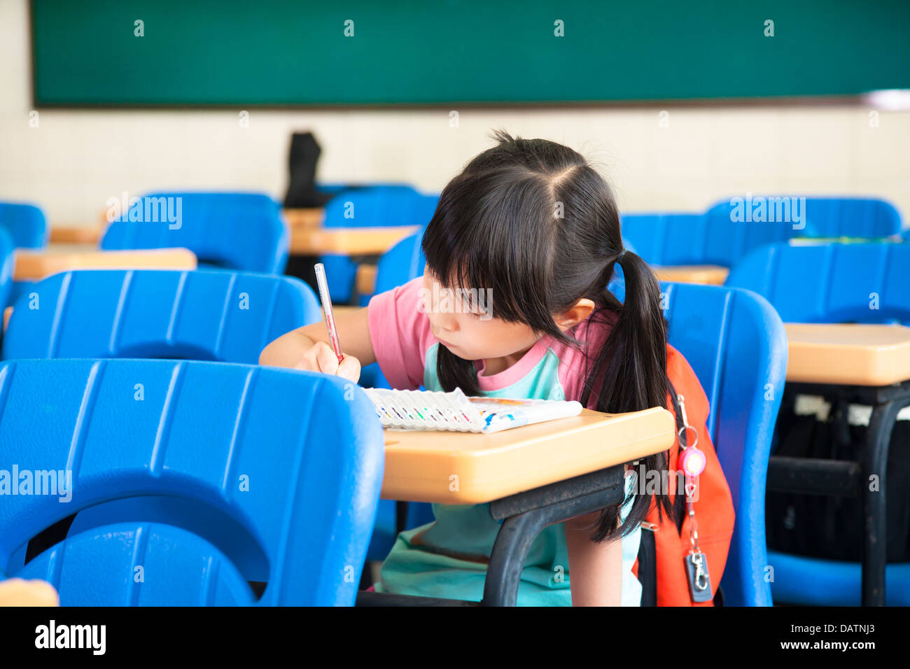 school girl study alone in the classroom Stock Photo - Alamy