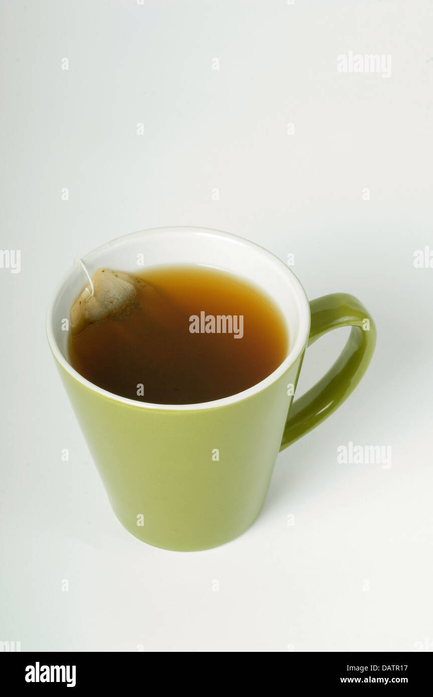 A mug of black tea with bag soaking on a white background Stock Photo ...