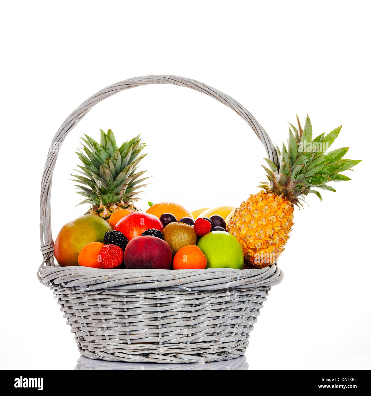 Composition with assorted fruits in wicker basket on white background ...