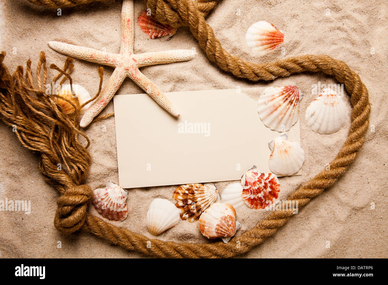 Shell, sand & sheet of paper Stock Photo - Alamy