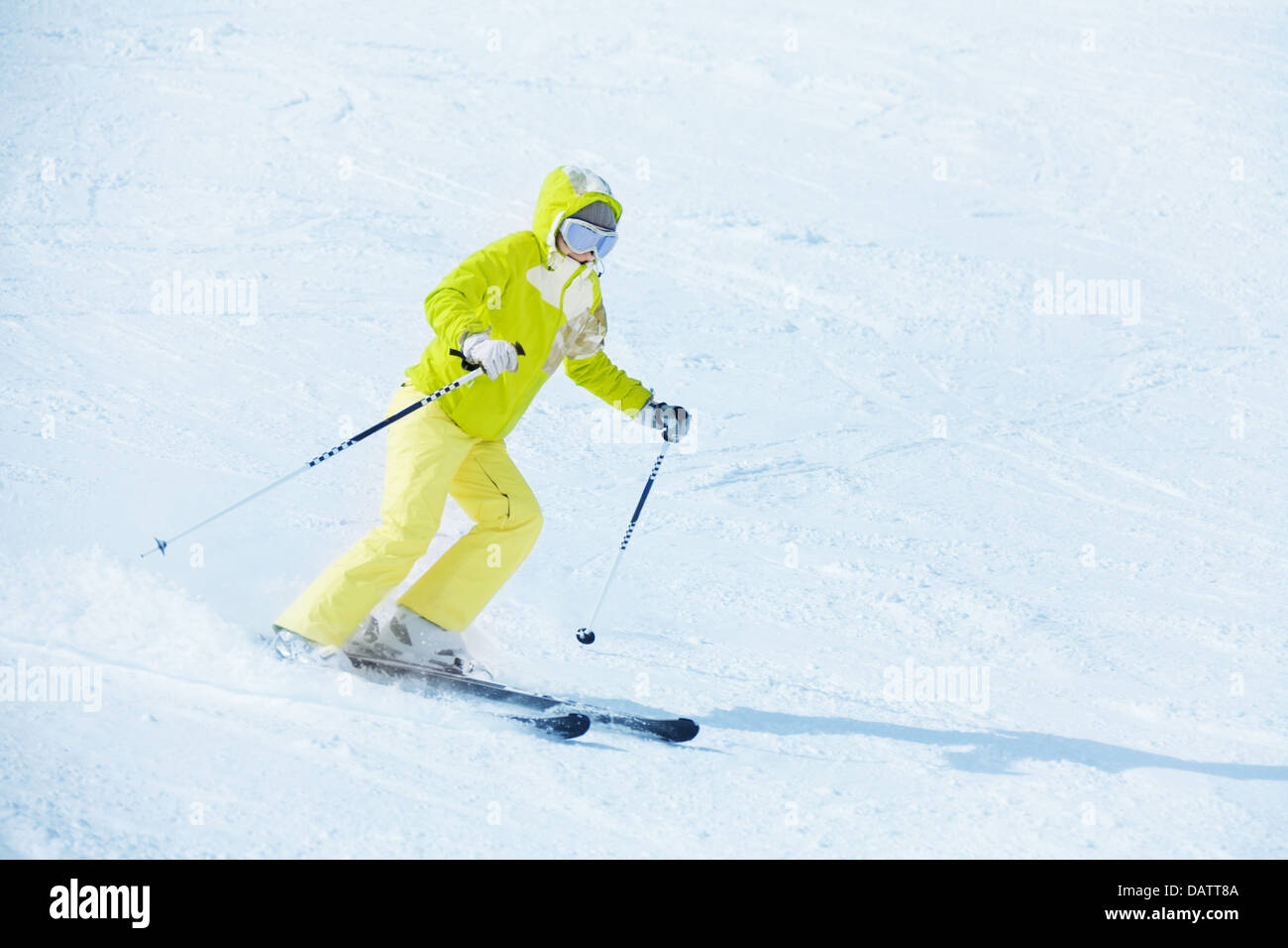 Yong happy skier woman sliding downhill with clean snow white ...