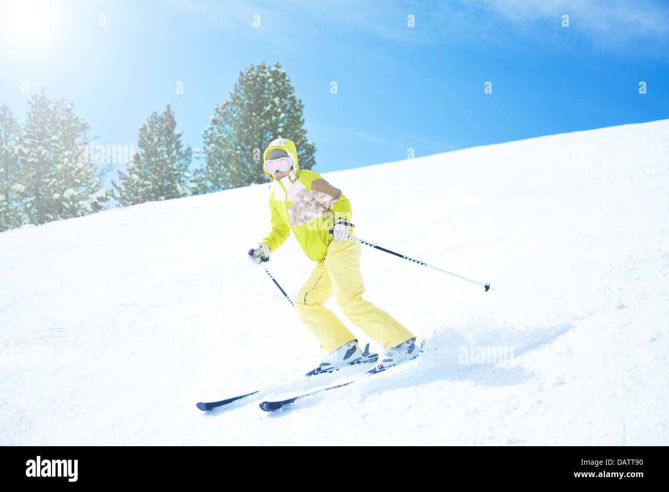 Young woman going downhill fast with clean white snow background Stock ...