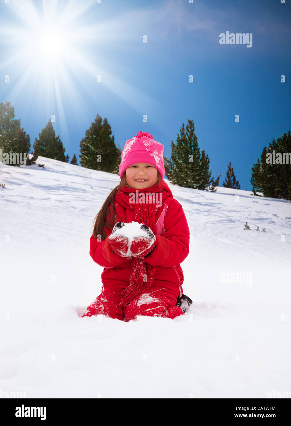 Little happy smiling girl about to throw snowball in the air Stock ...