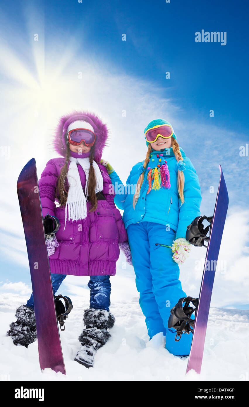 Two girls with snowboards together in snow having fun outside Stock ...