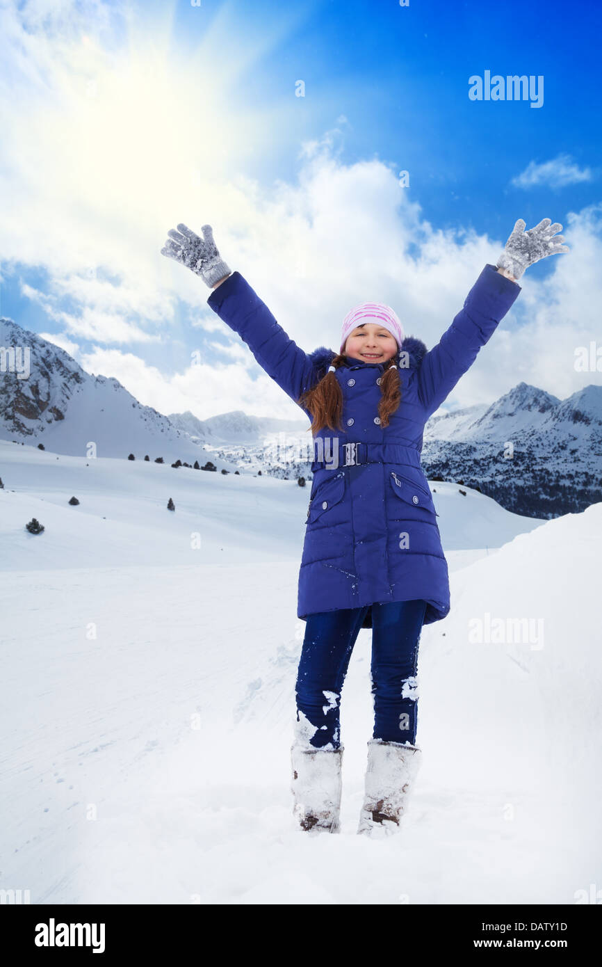 Happy 8 years old Caucasian girl in blue standing with lifted from ...