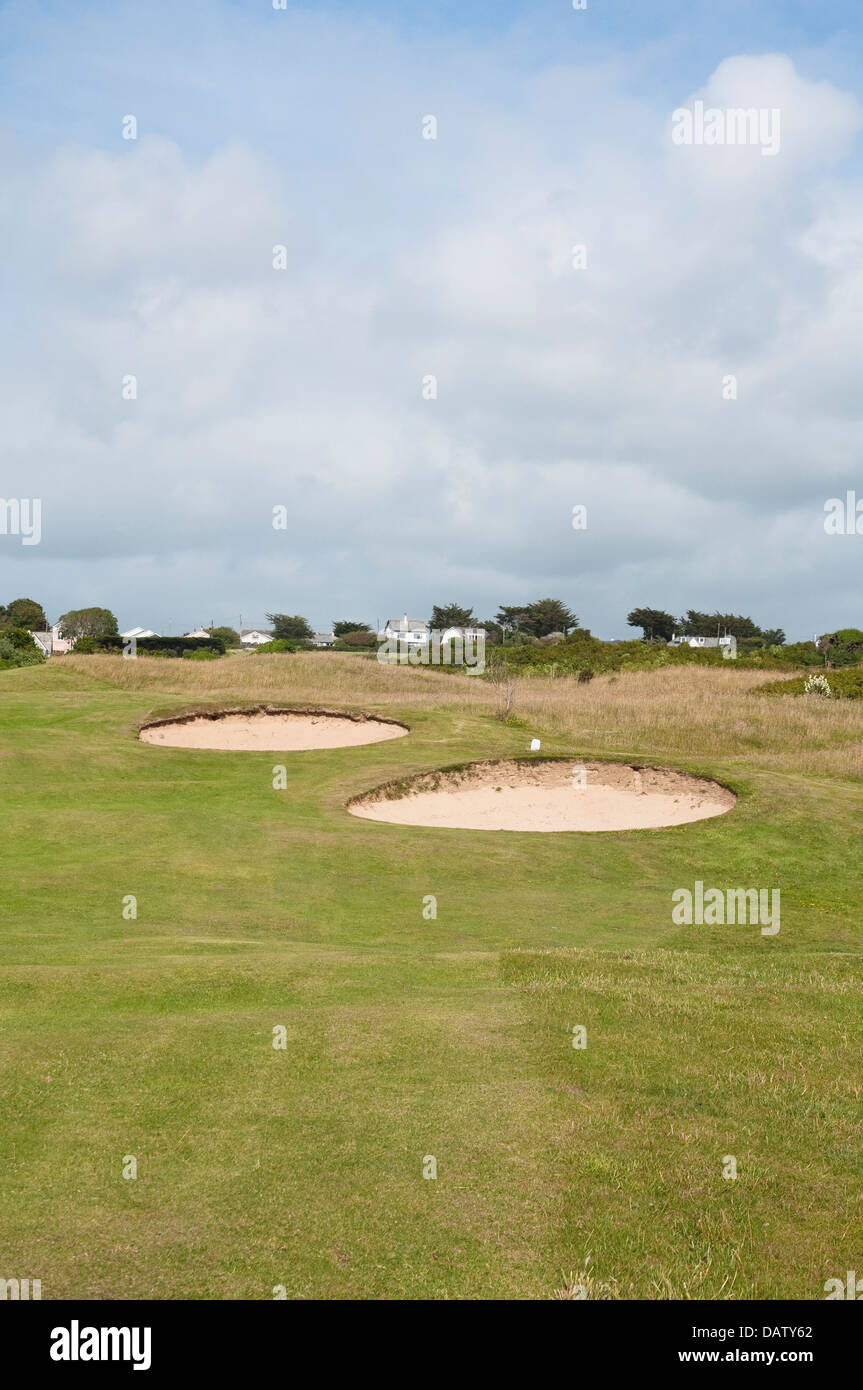 Bunkers at St Enodoc Golf Club, with houses on the distant horizon ...