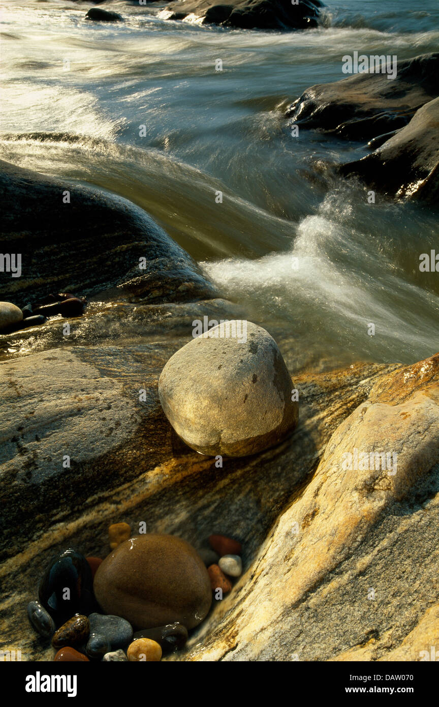 Round shaped pebbles along the water of the Olifants river, South ...