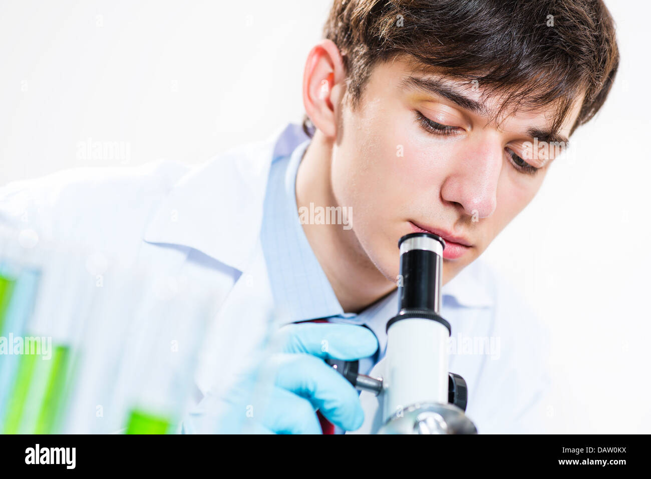 milled scientist looking into a microscope Stock Photo - Alamy