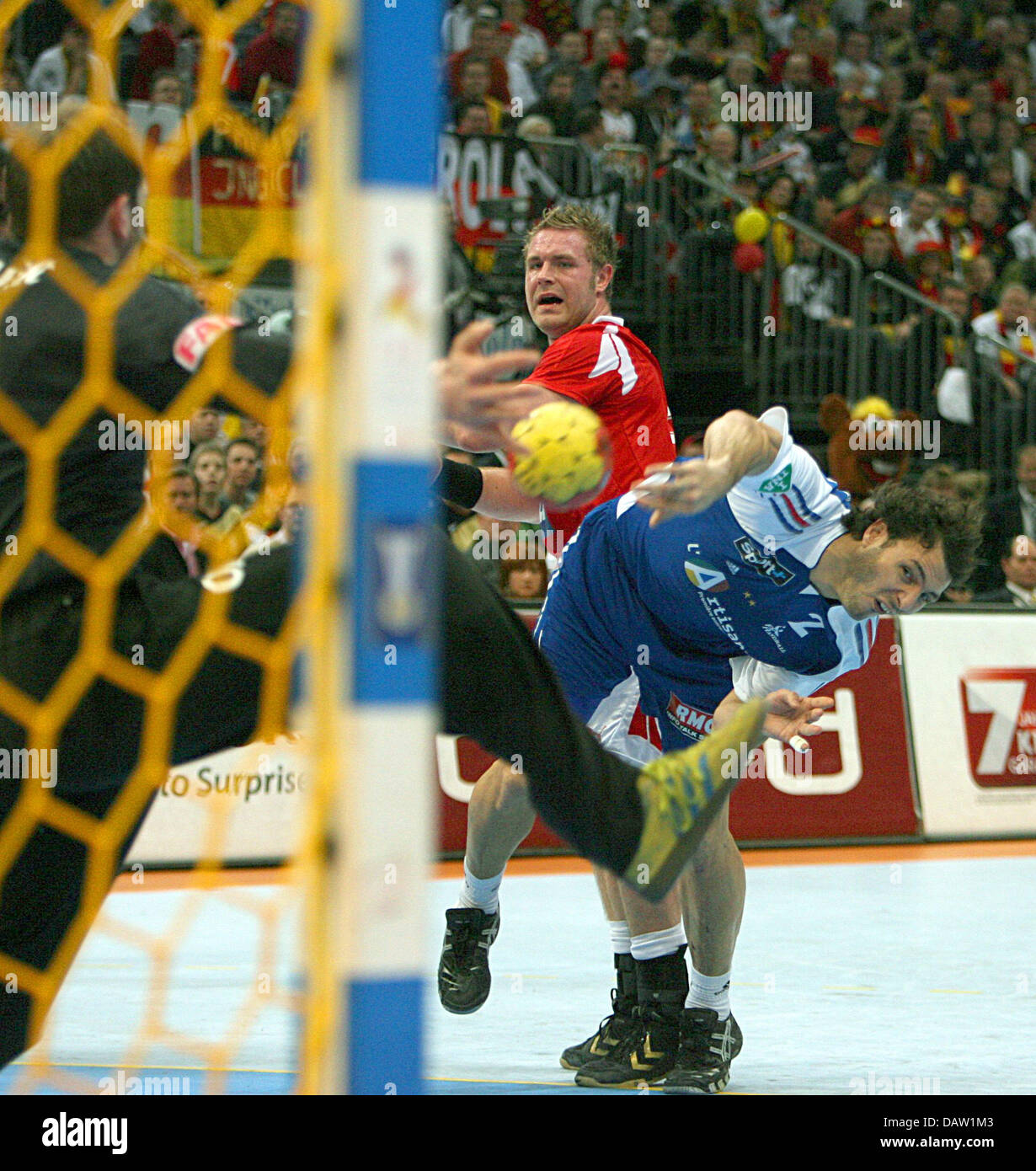 France's Jerome Fernandez (R) tries to score past Danish goalkeeper ...