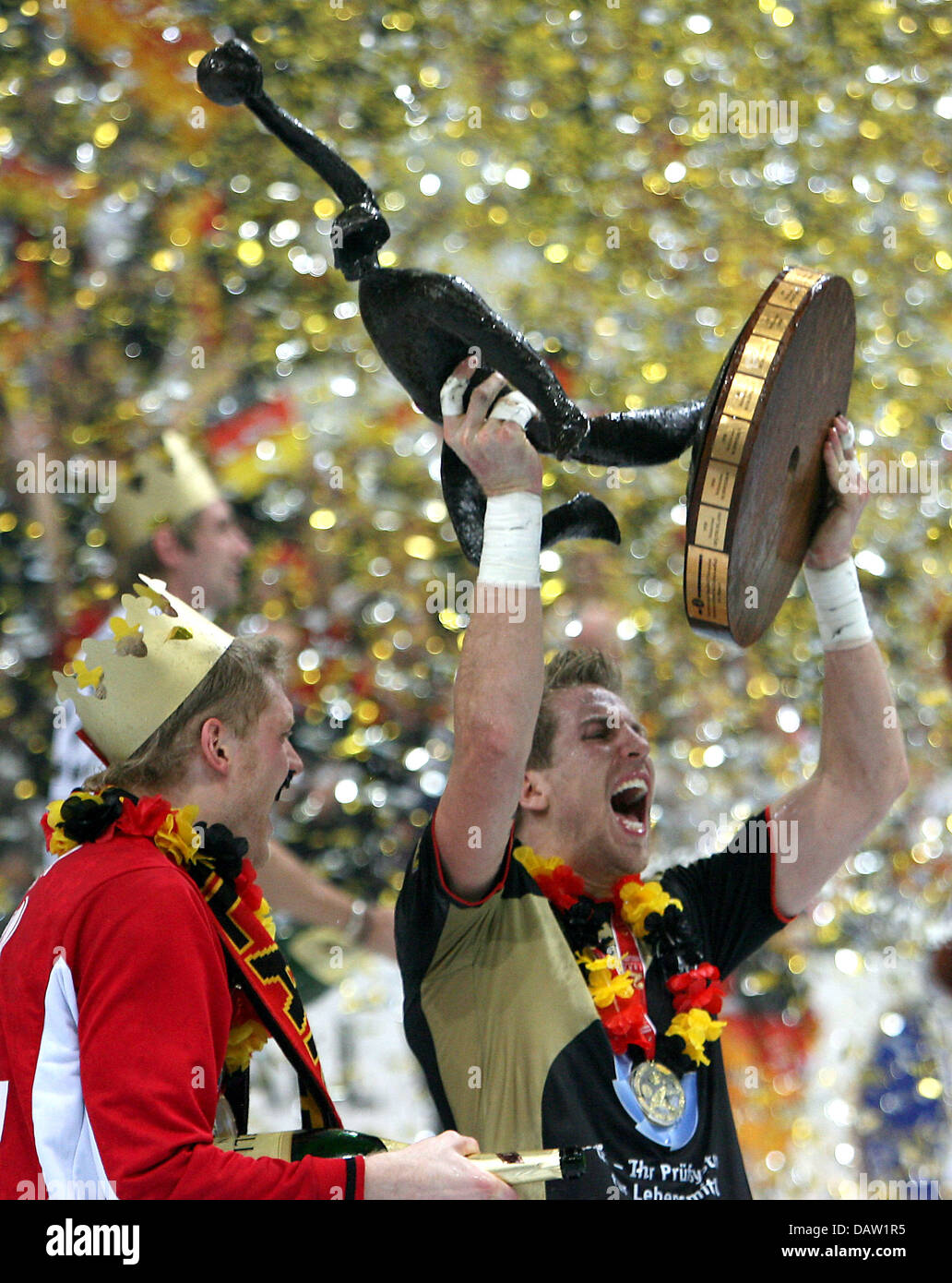 German national handball team player Oliver Roggisch lifts the winner's ...