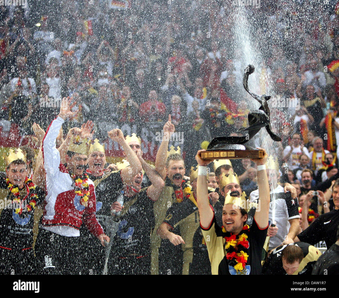 German national handball team captain Florian Kehrmann lifts the winner ...