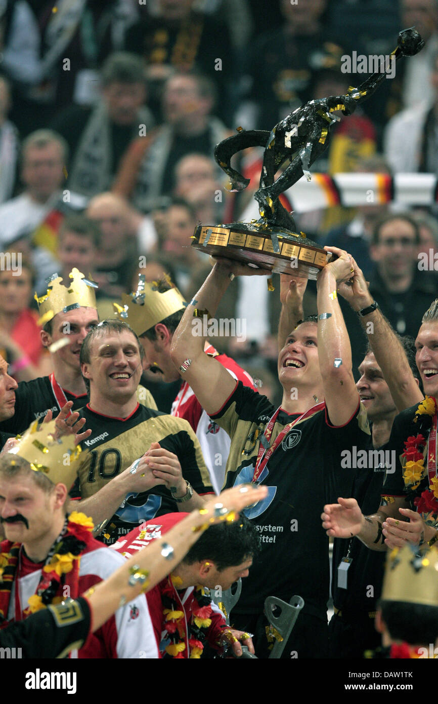 German national handball team player Sebastian Preiss lifts the winner ...