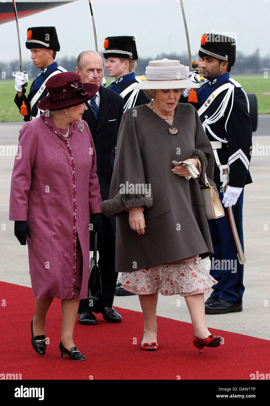 Britain's Queen Elizabeth II (L) and the Duke of Edinburgh are greeted ...