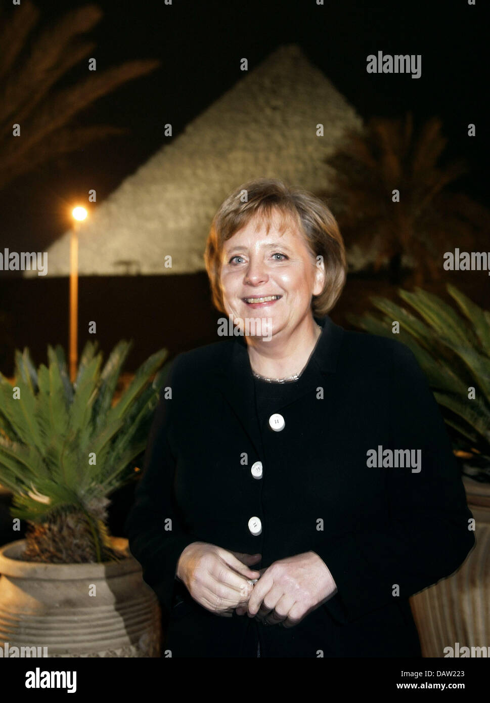 German Chancellor Angela Merkel smiles in front of a pyramid in Cairo ...