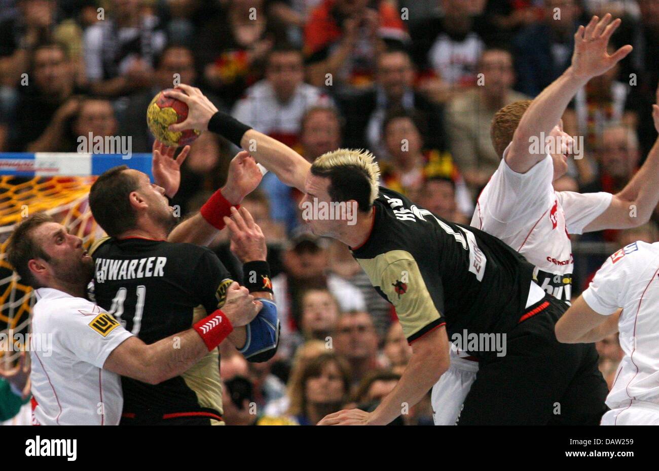 German players Pascal Hens (C) and Christian Schwarzer (2ndL) fight for ...