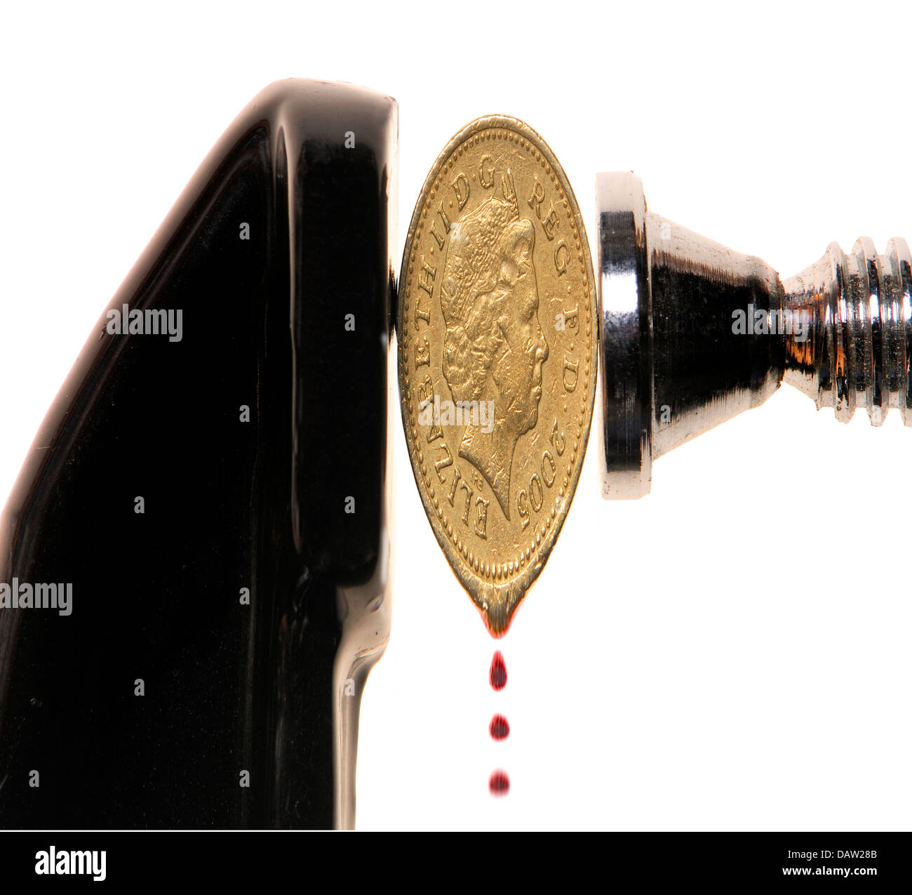 Pound coin being squeezed in a g-cramp - 'bleeding' Stock Photo - Alamy