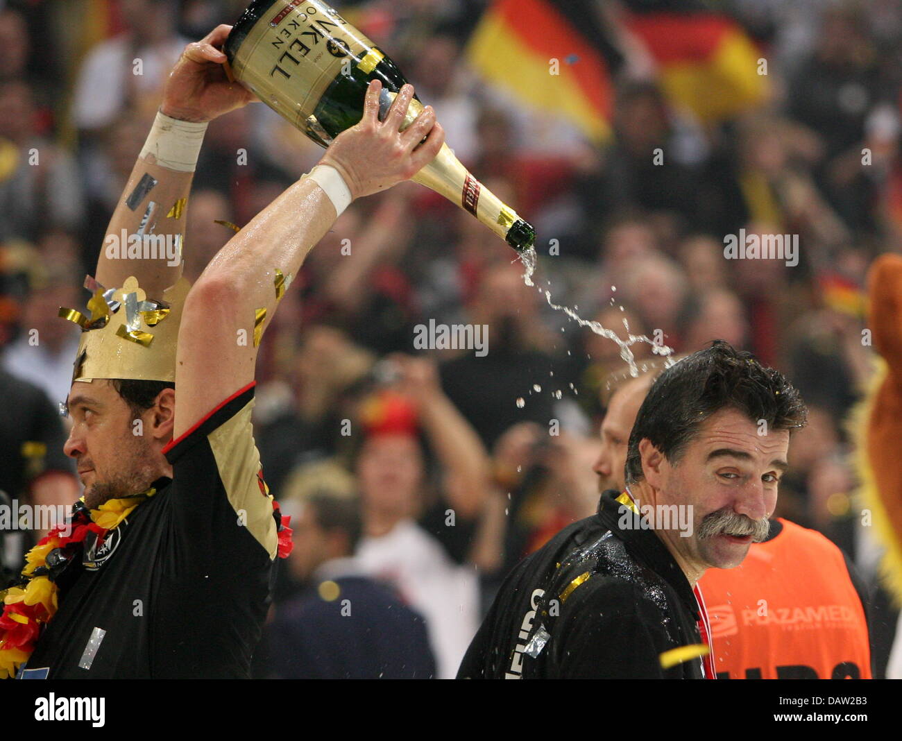 German head coach Heiner Brand (R) gets a champagne shower from skipper ...
