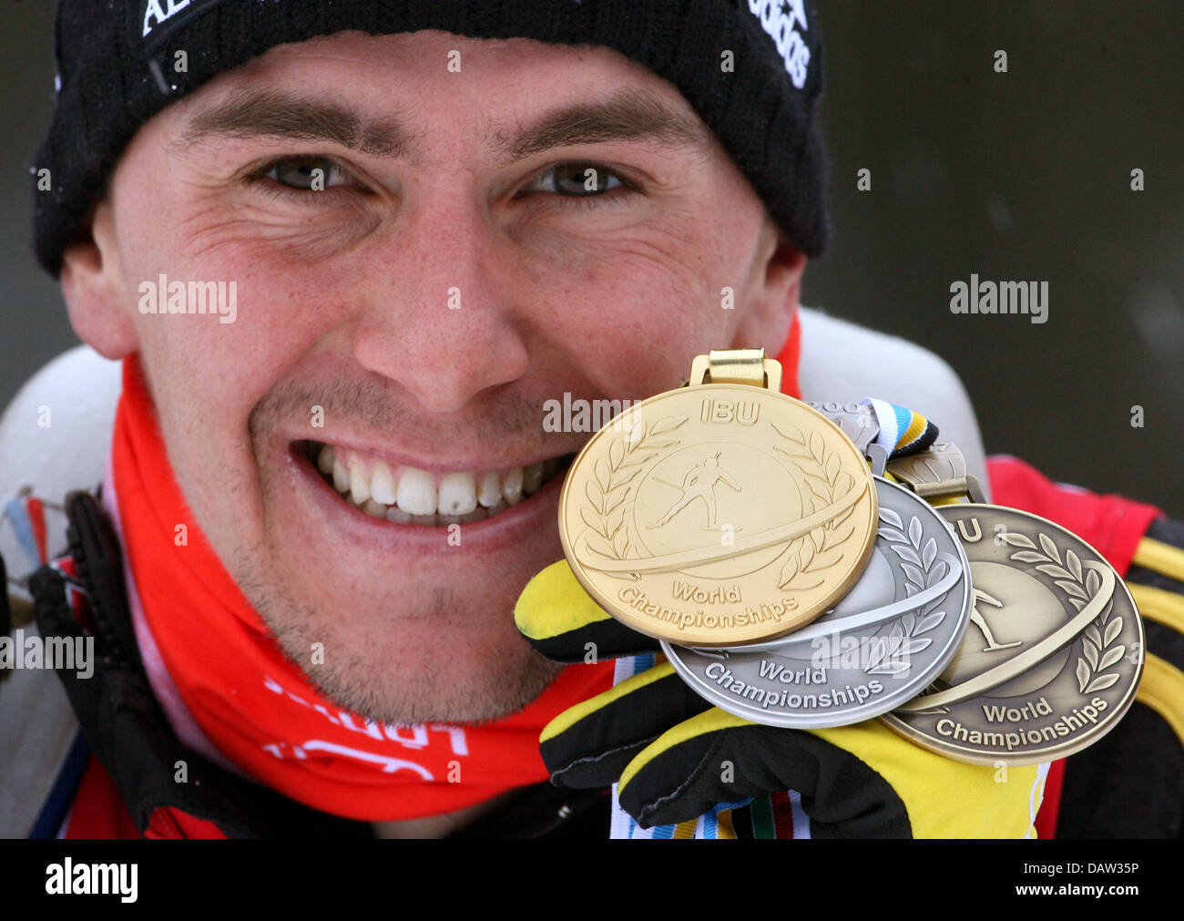 German Michael Greis presents his three medals after the 15 km men's ...