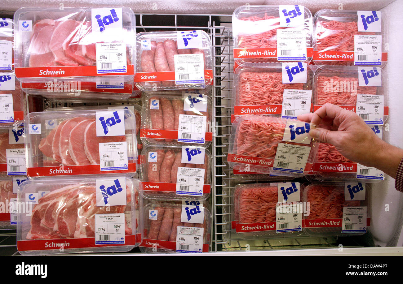 A customer takes minced meat of the REWE owned ja! brand out of a ...