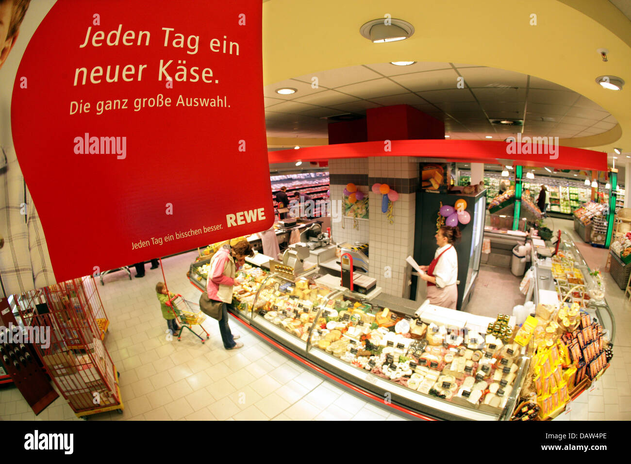 A customer looks at the broad range of cheese varieties in a ...