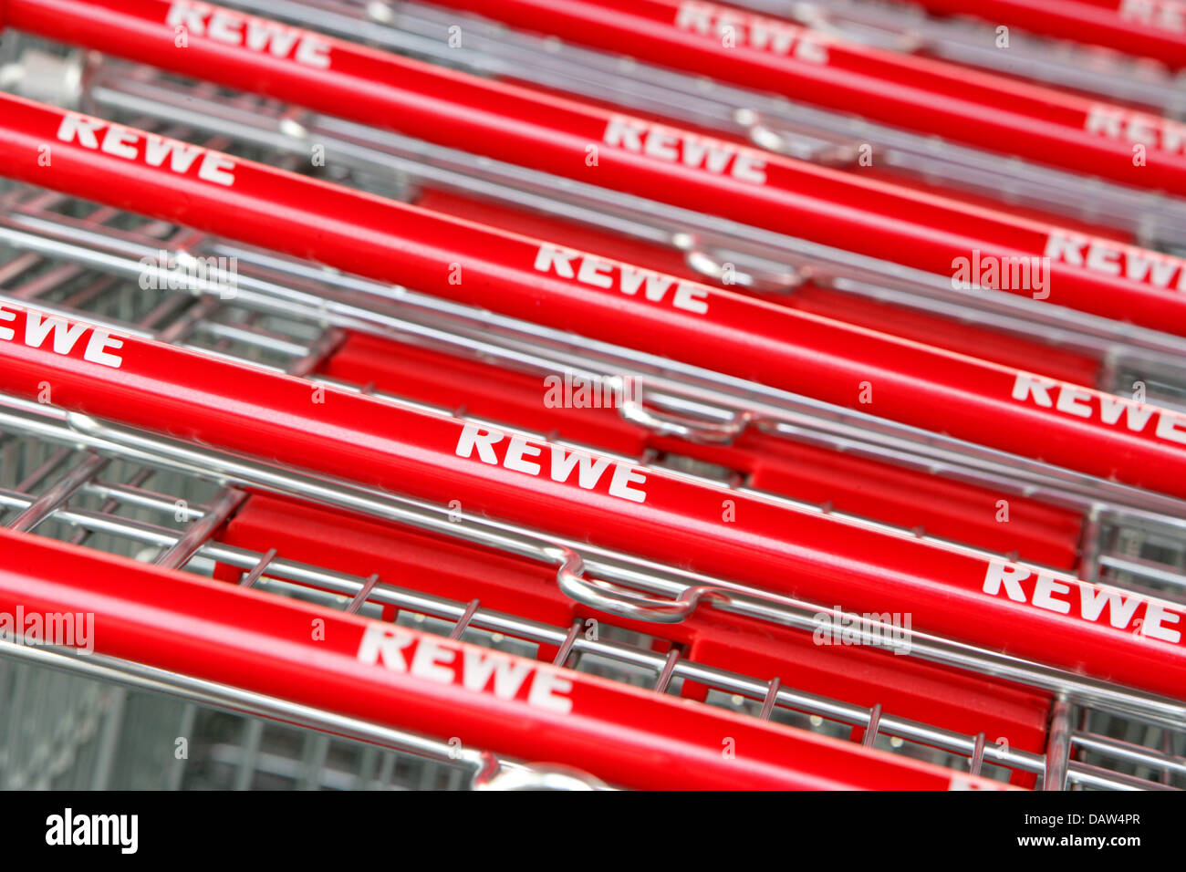 Shopping trolleys featuring the REWE logo are pictured in the entrance ...