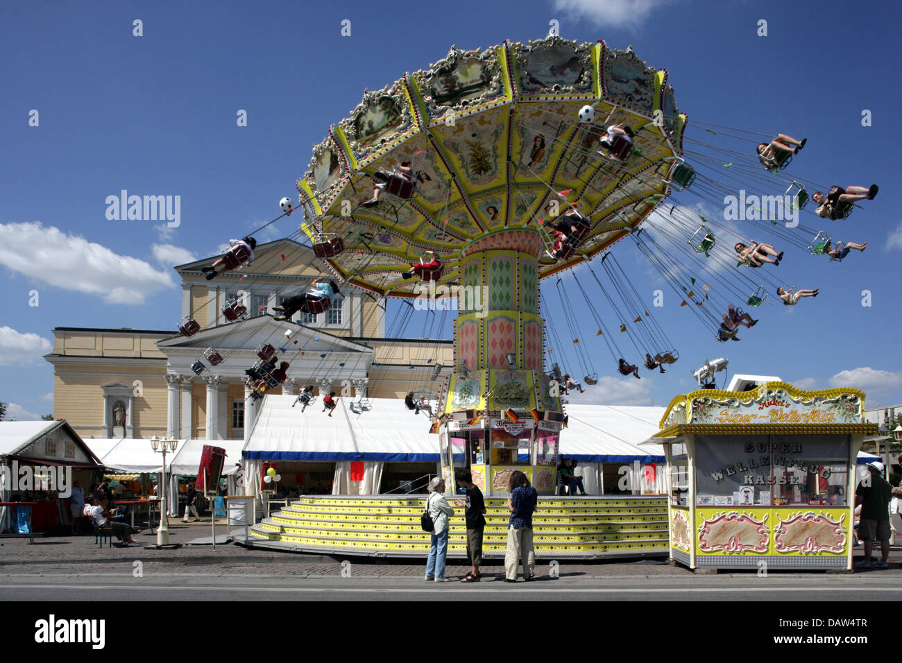 Visitors ride a roundabout at the Heinerfest (festival) in Darmstadt ...