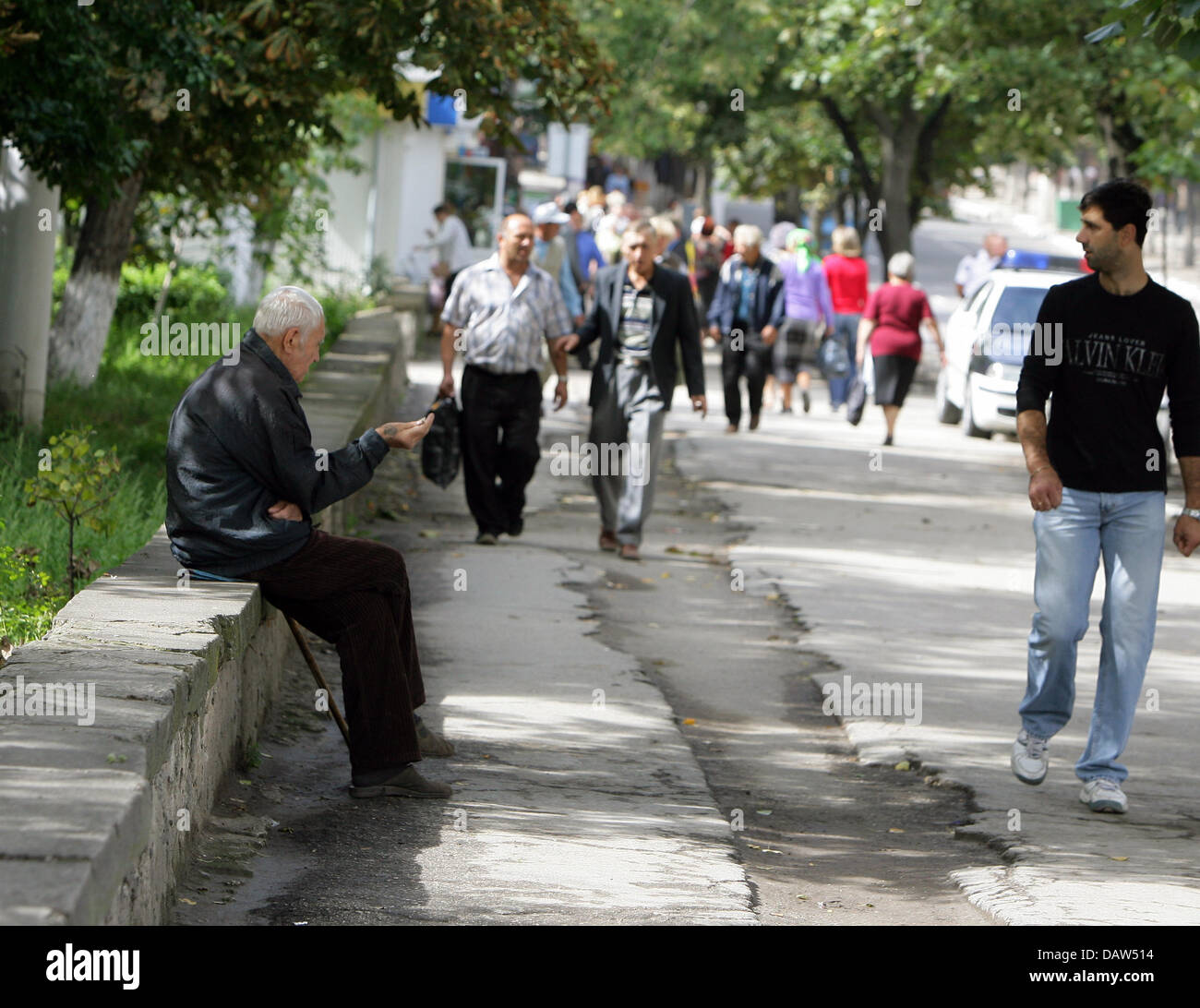 An old man begs for alms in the city center of Balti, Moldova, 30 ...