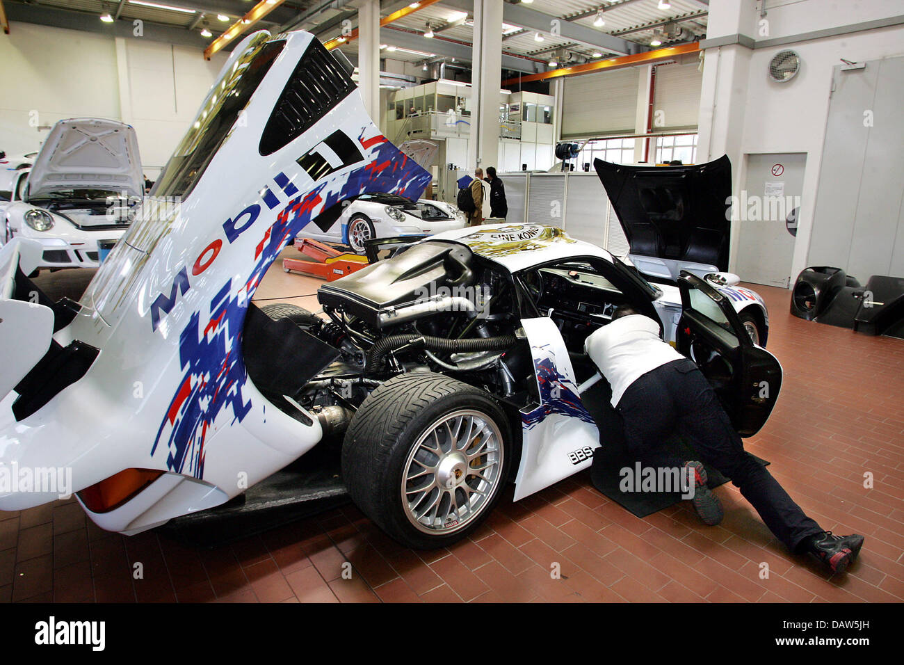 A mechanic prepares a race car at the motor sports centre of Porsche in ...