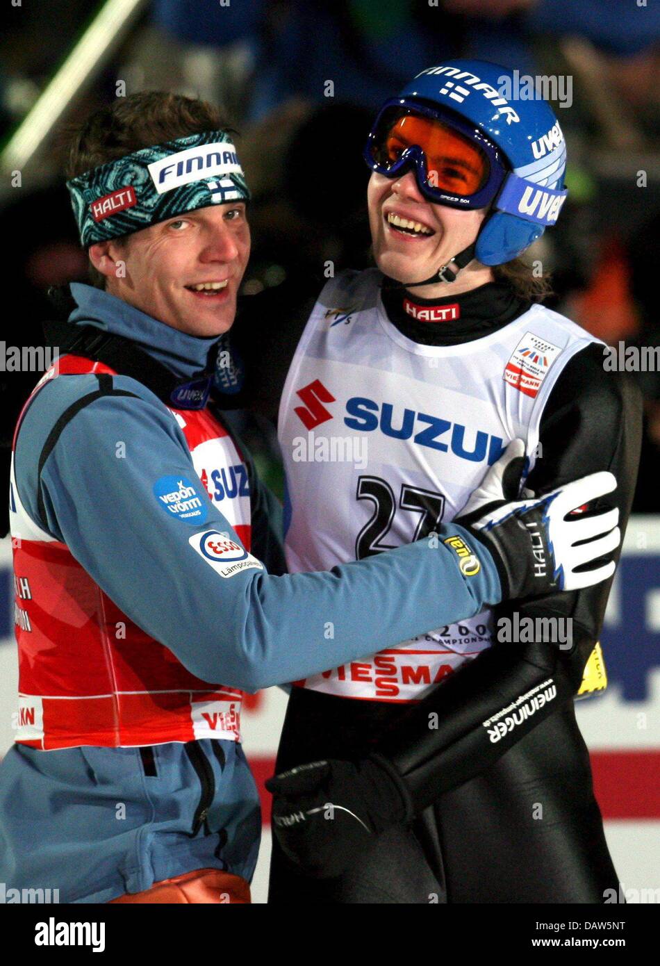 Finnish ski jumper Harri Olli (R) cheers his silver medal jump with ...