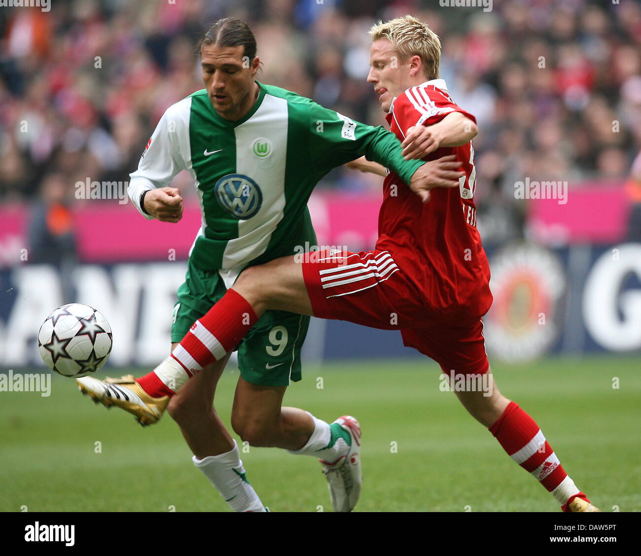 Christian Lell (R) of Munich clears the ball off Wolfsburg's Diego ...