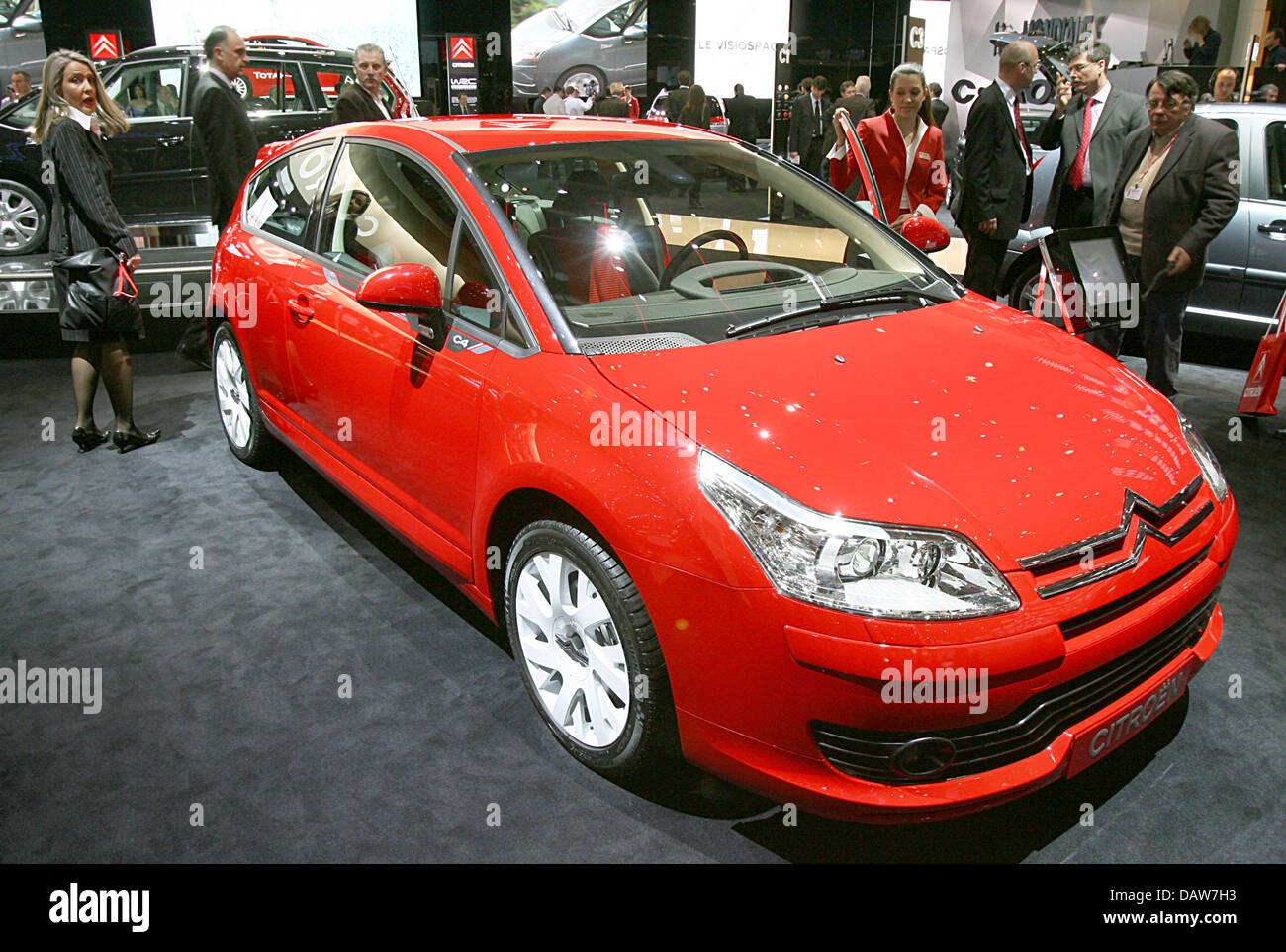 Visitors look at a new Citroen C4 at the Geneva Motor Show in Geneva ...